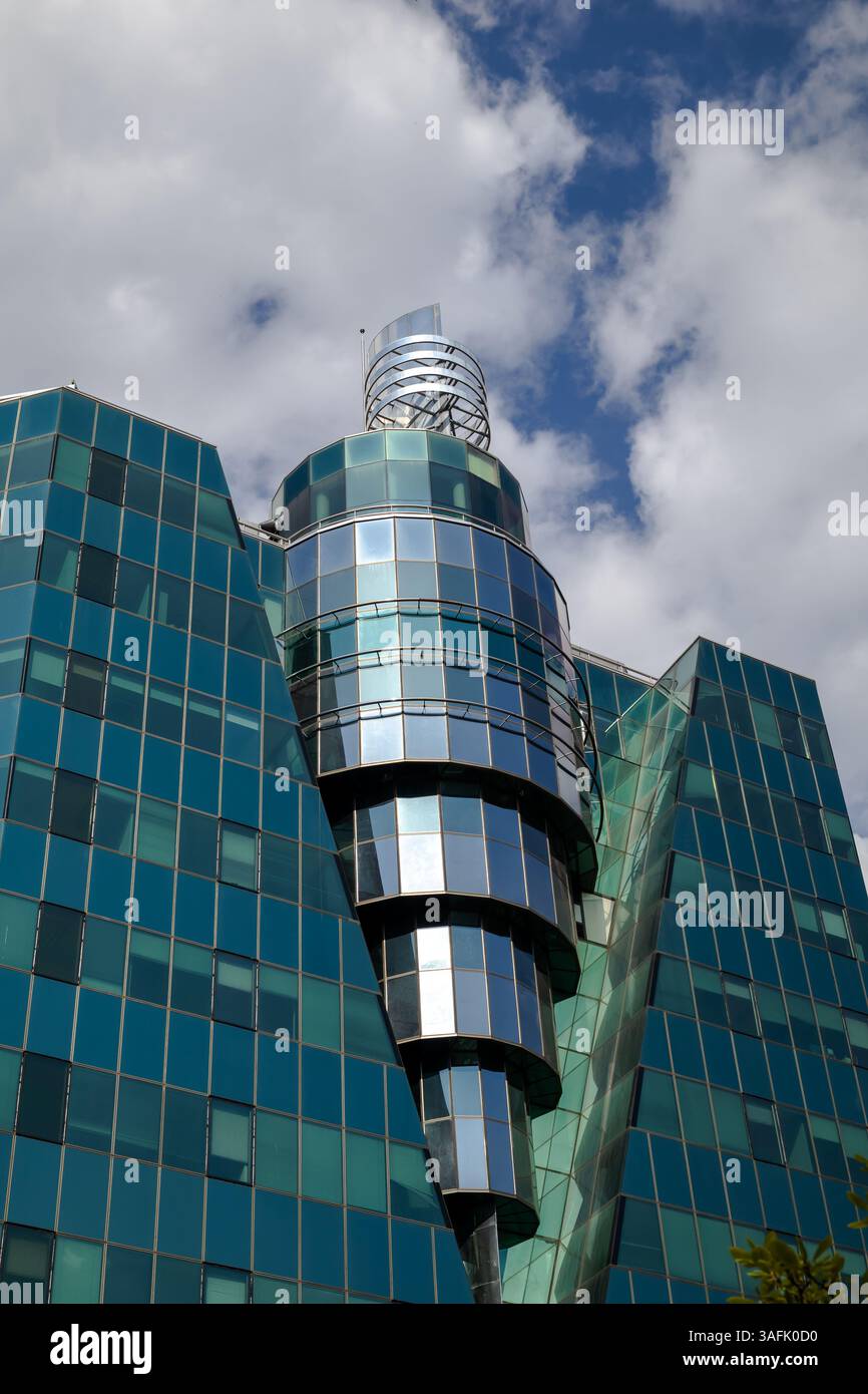 Modern Blue Glass Building with Cylindrical Tower Stock Photo - Alamy
