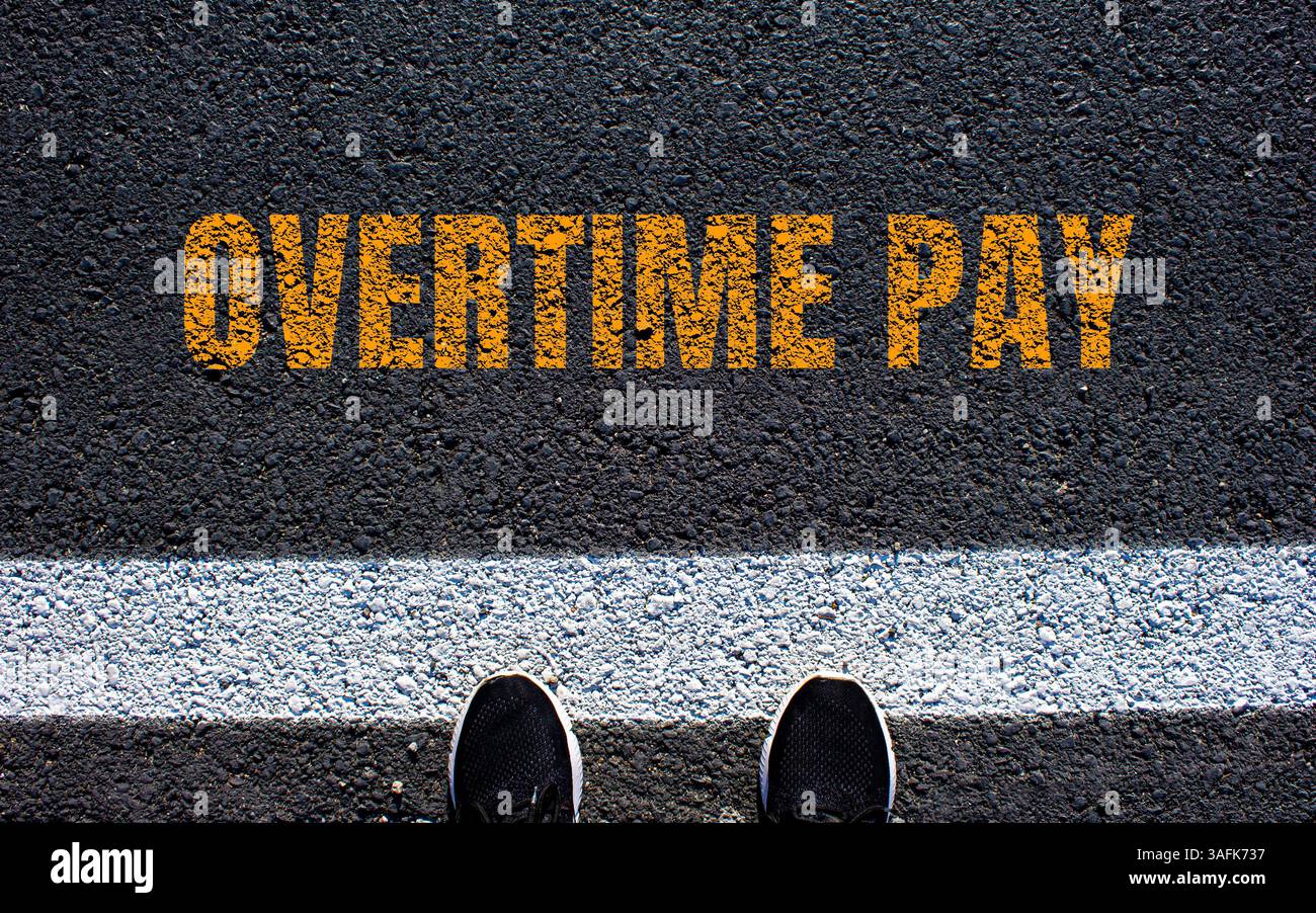 Overtime pay message written on asphalt road. Conceptual overtime pay ...