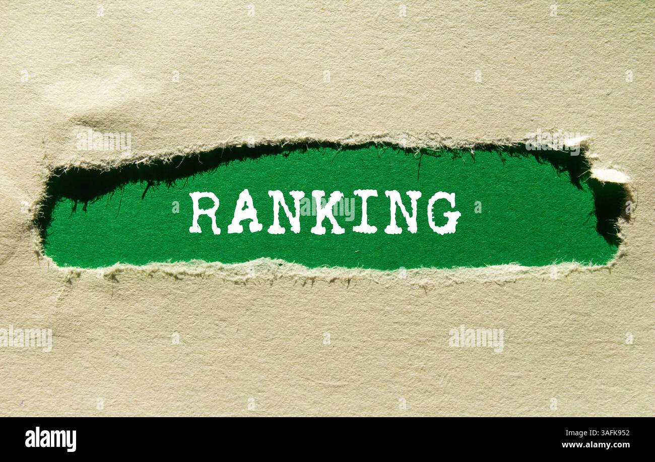 Ranking message written on ripped torn paper on green background ...