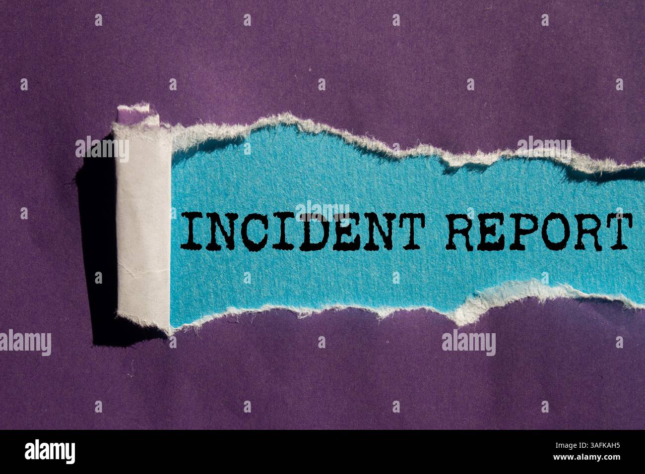 Incident report message written on ripped torn purple paper on blue background. Conceptual ...