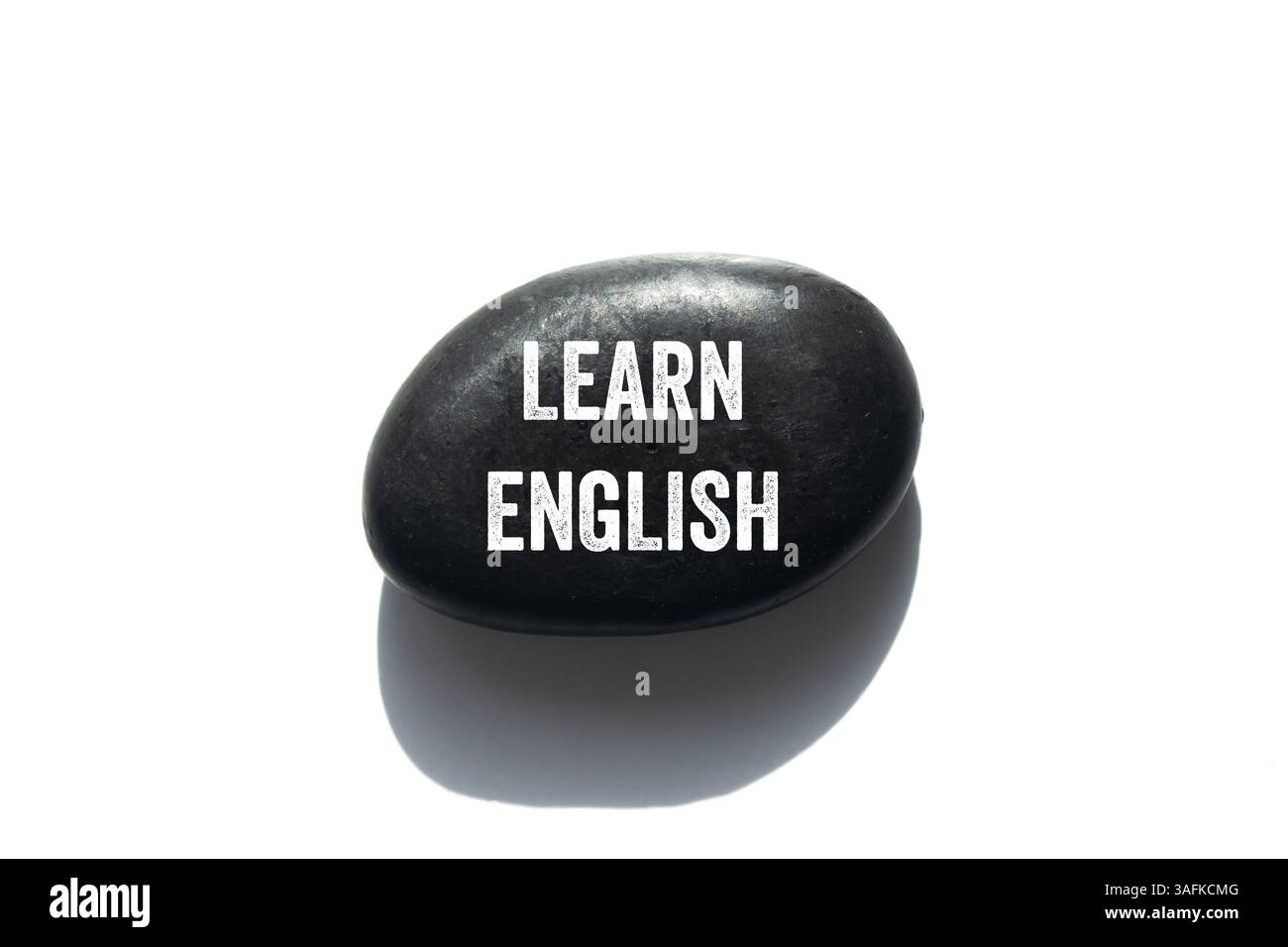 Learn english message written on black stone on white background ...