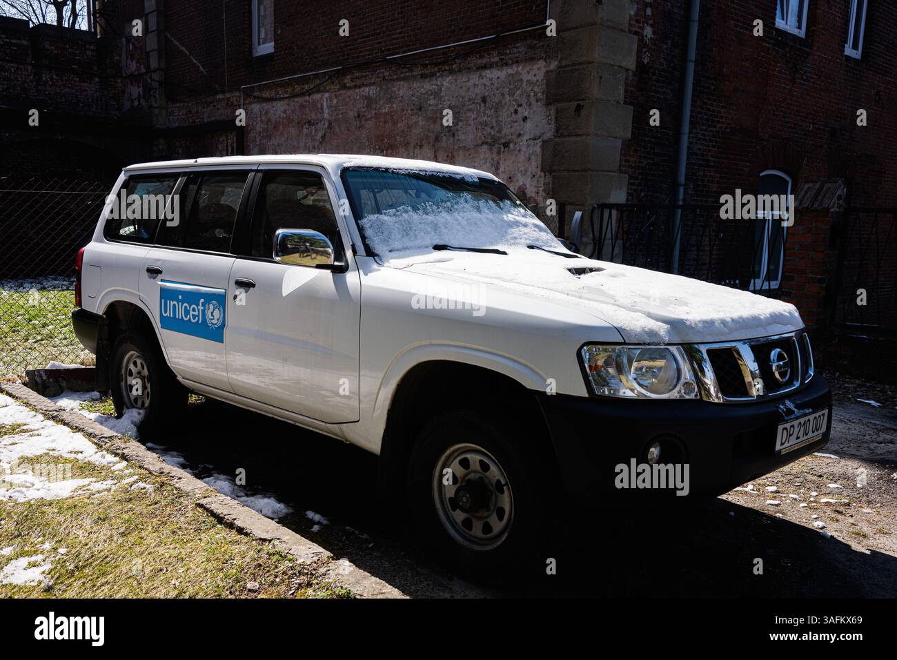 Lviv, Ukraine - April 06, 2025: Snow-covered Nissan Patrol vehicle with ...
