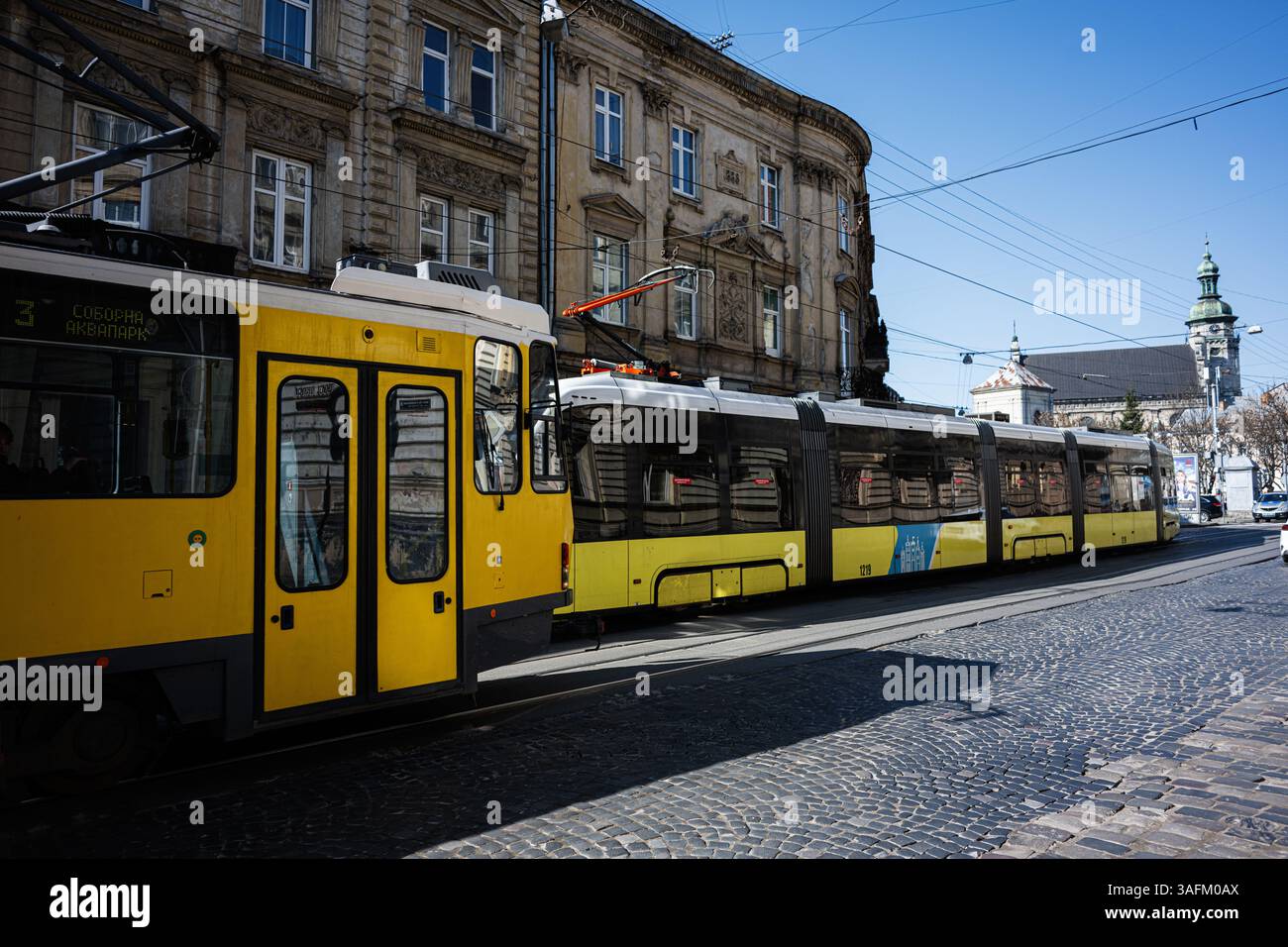 Lviv, Ukraine - April 06, 2025: A vibrant yellow tram rides along ...
