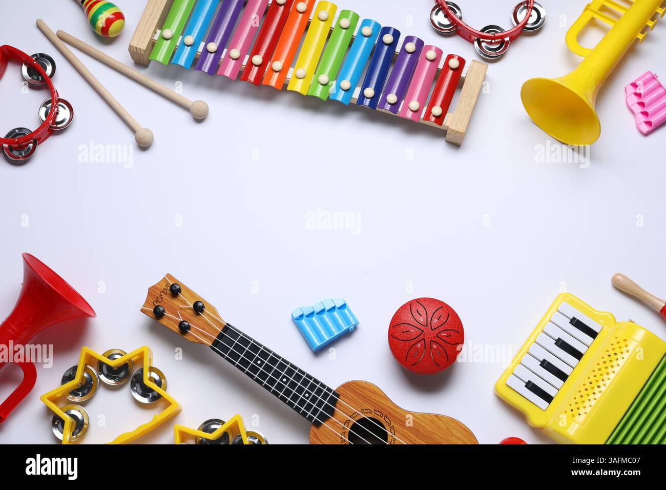 Flat lay composition with different toy musical instruments on white ...