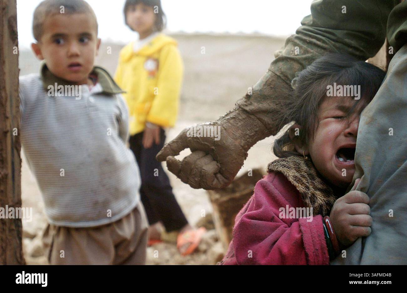 Amena Husen, 2, screams for the mud covered hand of her father after ...