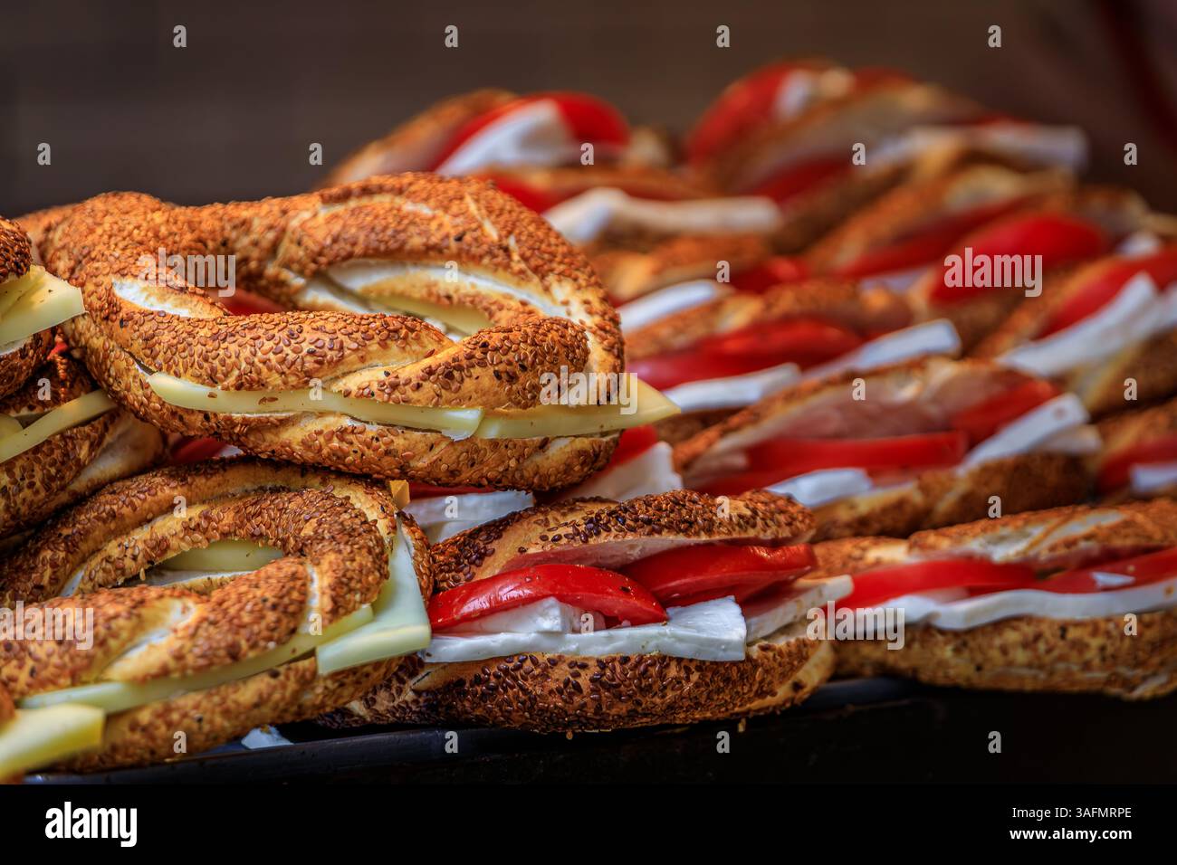 Stacked traditional simit sandwiches with cheese and tomato prepared ...