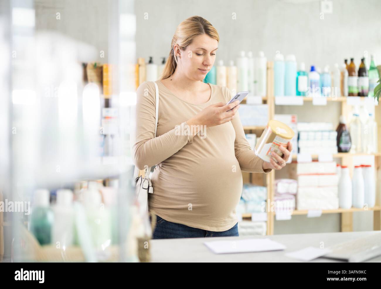 Pregnant woman scanning qr code of baby formula Stock Photo - Alamy