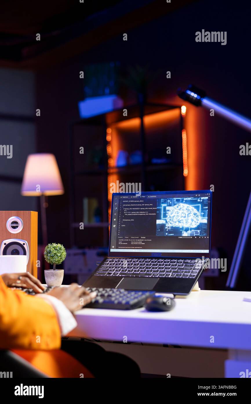 Computer scientist using laptop, updating artificial intelligence ...