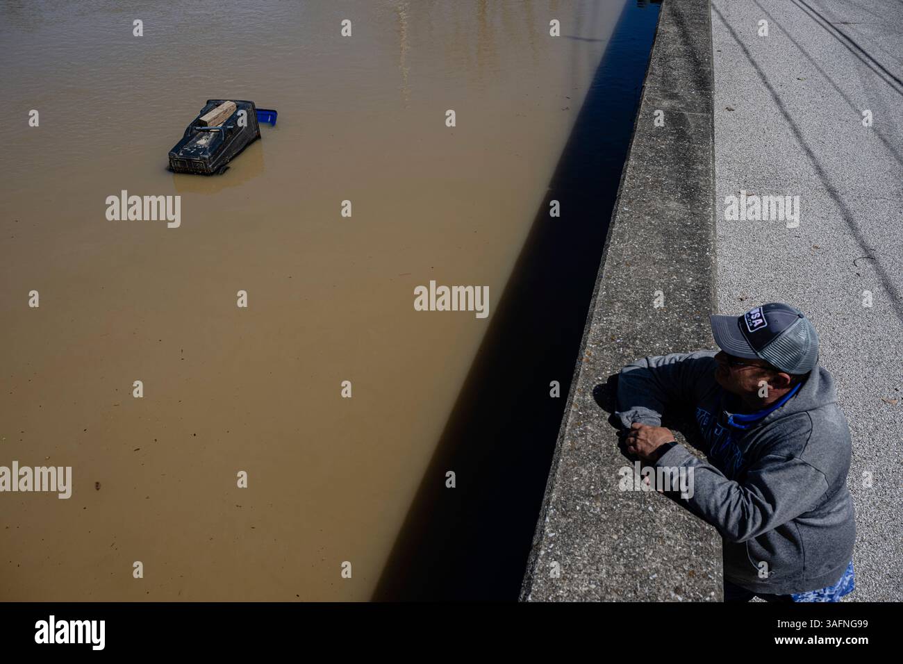 A resident looks out over the flood wall on Monday, April 7, 2025, in ...