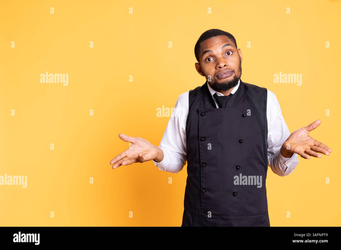 Clueless african american waiter expressing his uncertainty and acting ...