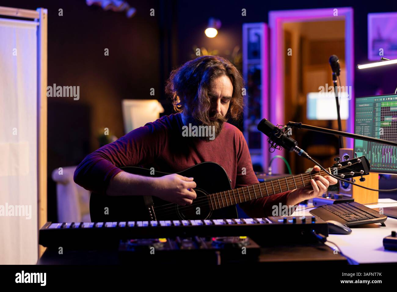 Musician with condenser microphone creating a song on guitar, working ...