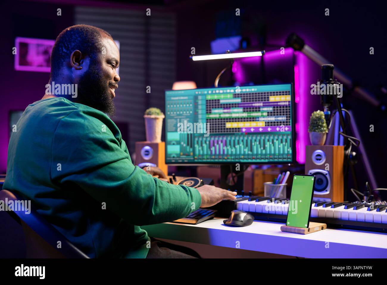 Composer musician mixing his tracks in pc software with an isolated ...