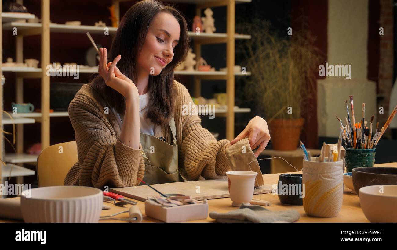 Thoughtful woman Caucasian girl female potter artist designer painter ...