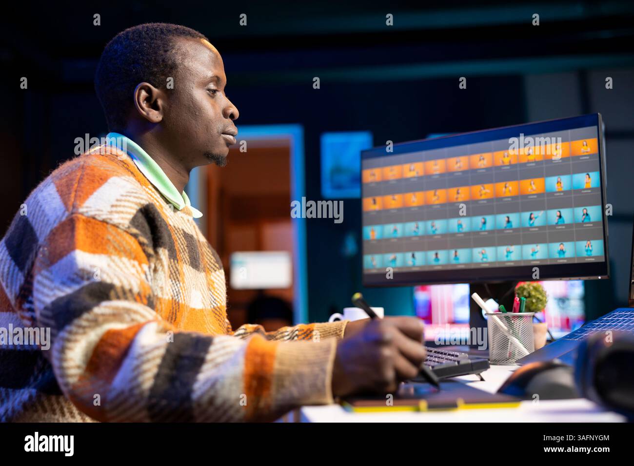 Freelance graphic designer working from home office on editing photos ...