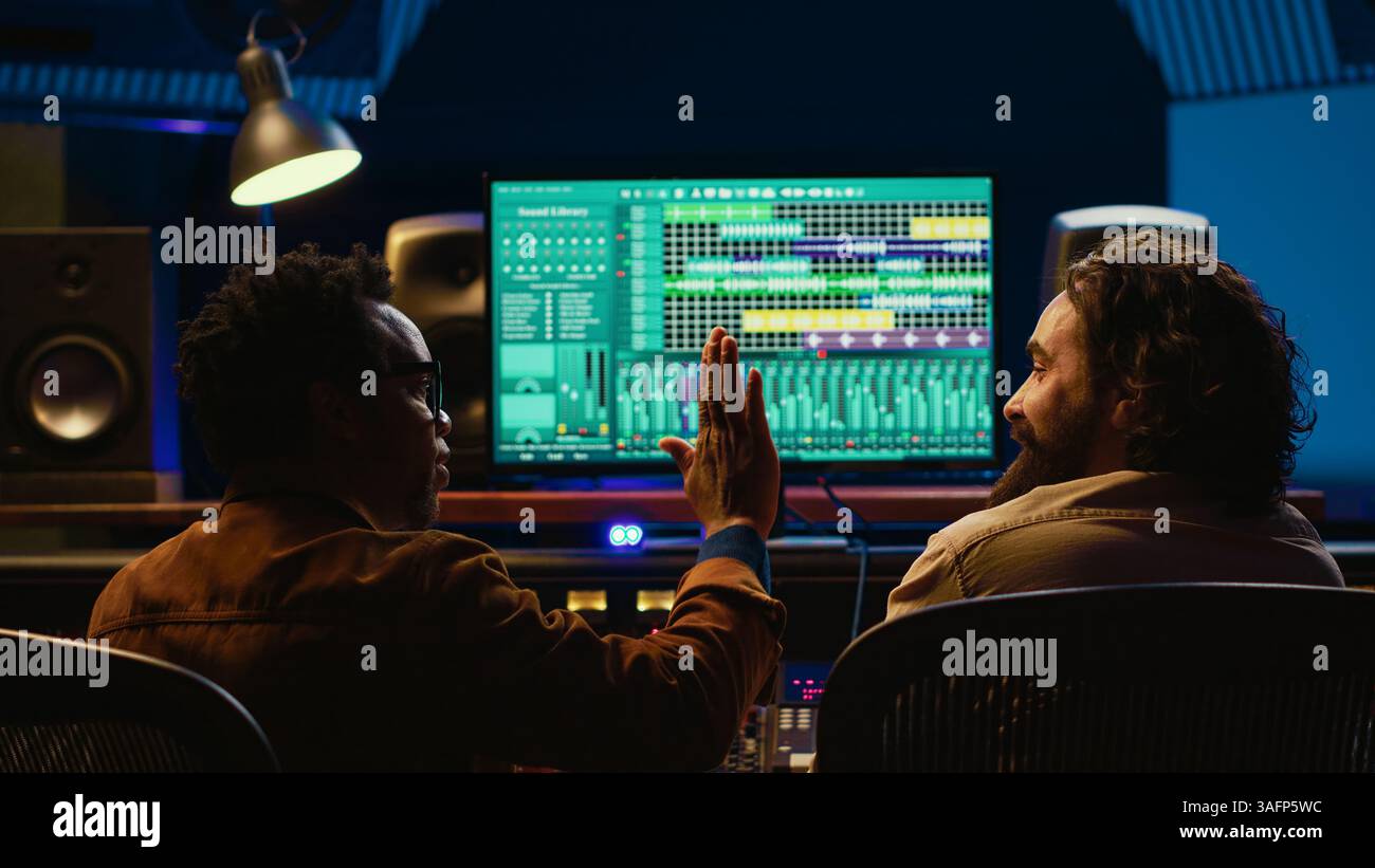 Pleased artist and tracking engineer doing high five gesture after ...