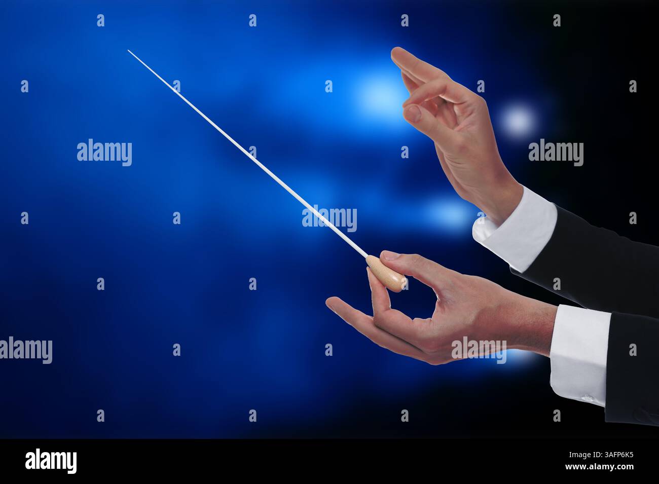 Conductor with baton in concert hall, closeup Stock Photo - Alamy