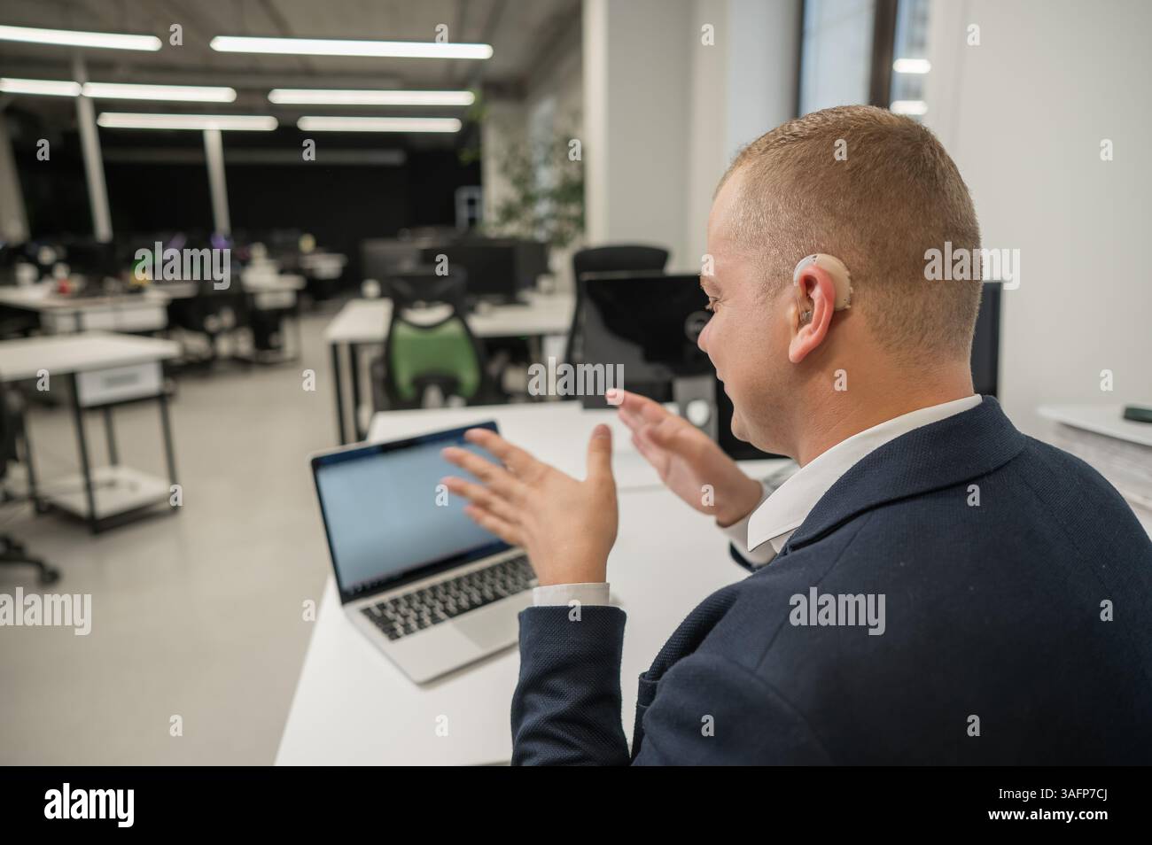 Caucasian deaf man communicates in sign language on laptop in office ...