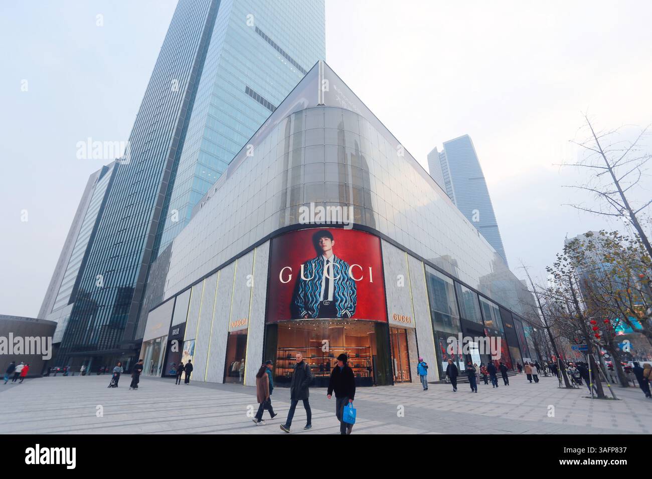 Pedestrians pass a store of Italian luxury brand Gucci in Shanghai ...