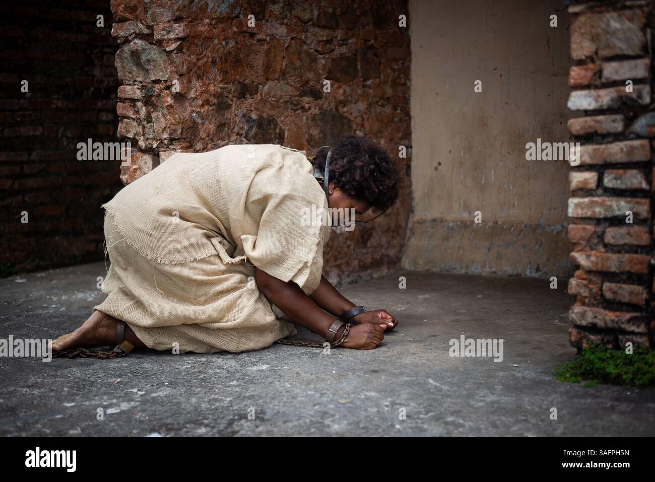 Portrait of a black woman in chains, with an iron mask over her mouth ...