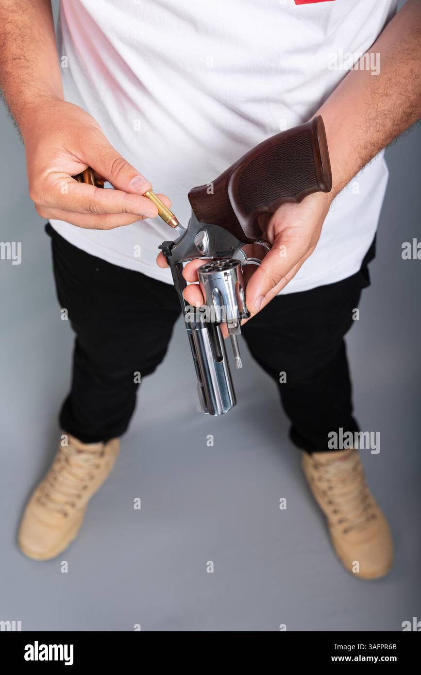 Top down view of a shooting instructor wearing black pants and white ...