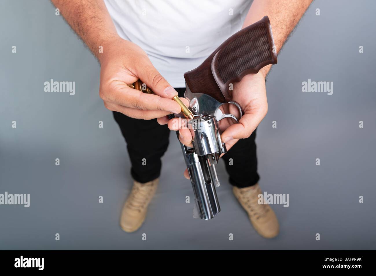 Top down view of a shooting instructor wearing black pants and white ...