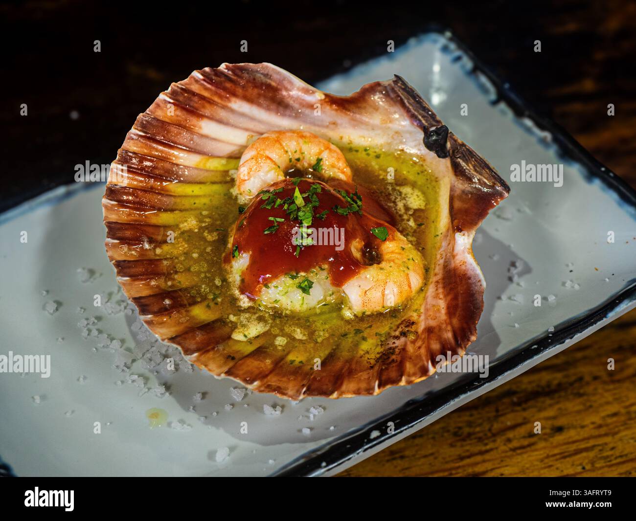 A gourmet presentation featuring a plump shrimp nestled inside a ...