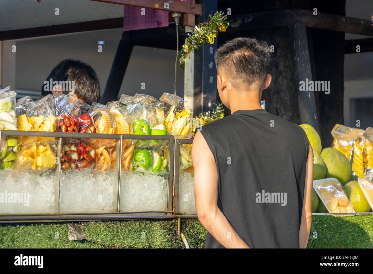 People choosing chilled fruit at a street kiosk, Thailand Stock Photo ...