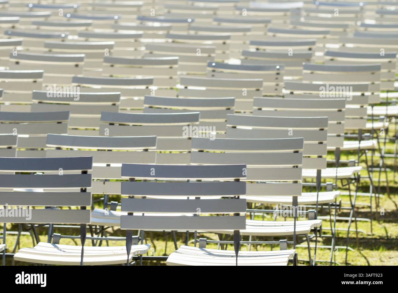 White rows of chairs in a dark spa park Stock Photo - Alamy