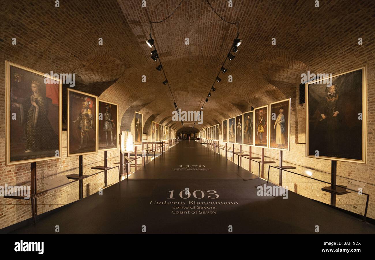 Long gallery corridor with historical paintings and brick vaults ...