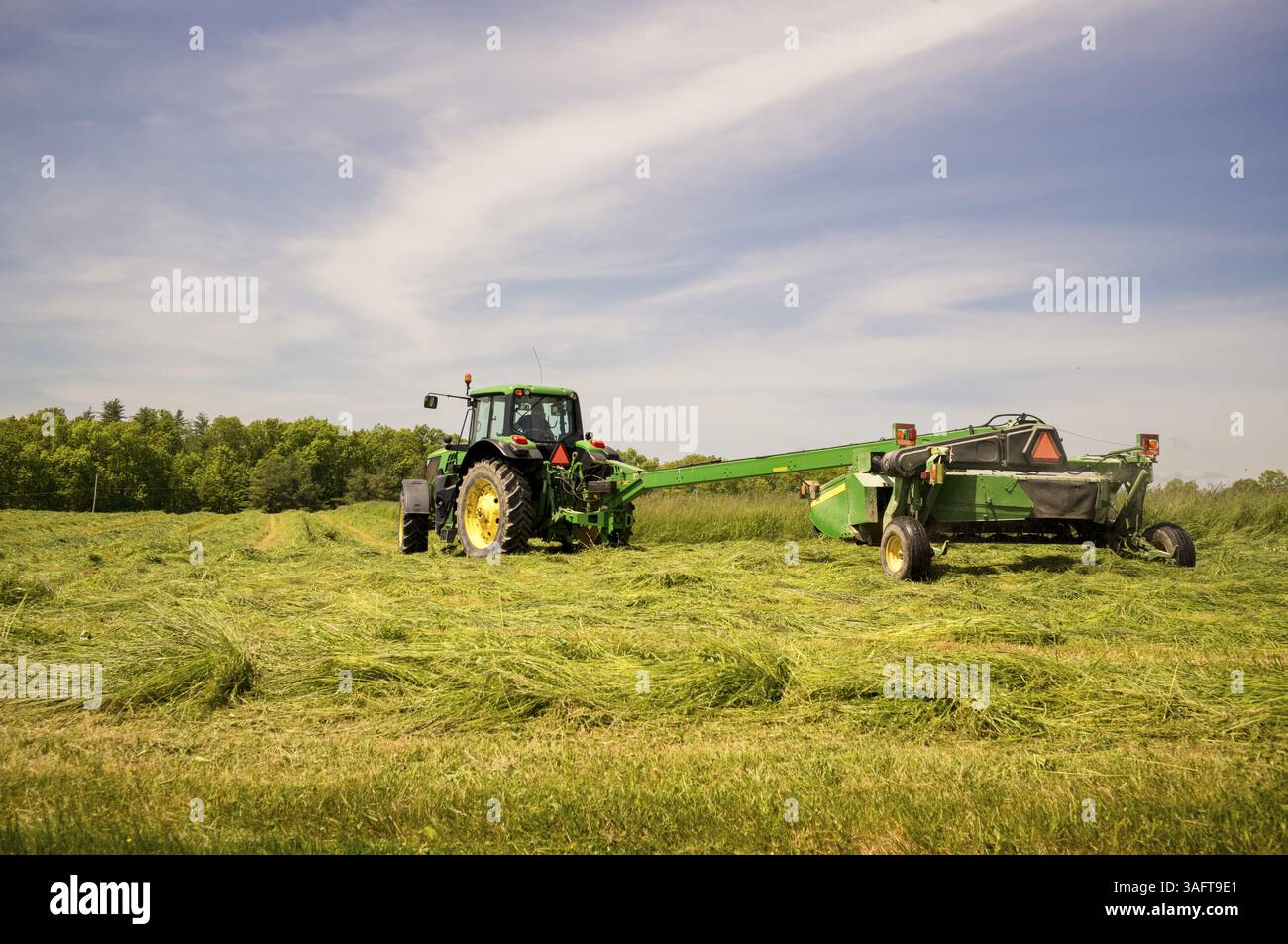 Big American tractor working on a farm with specialised equipement, New ...