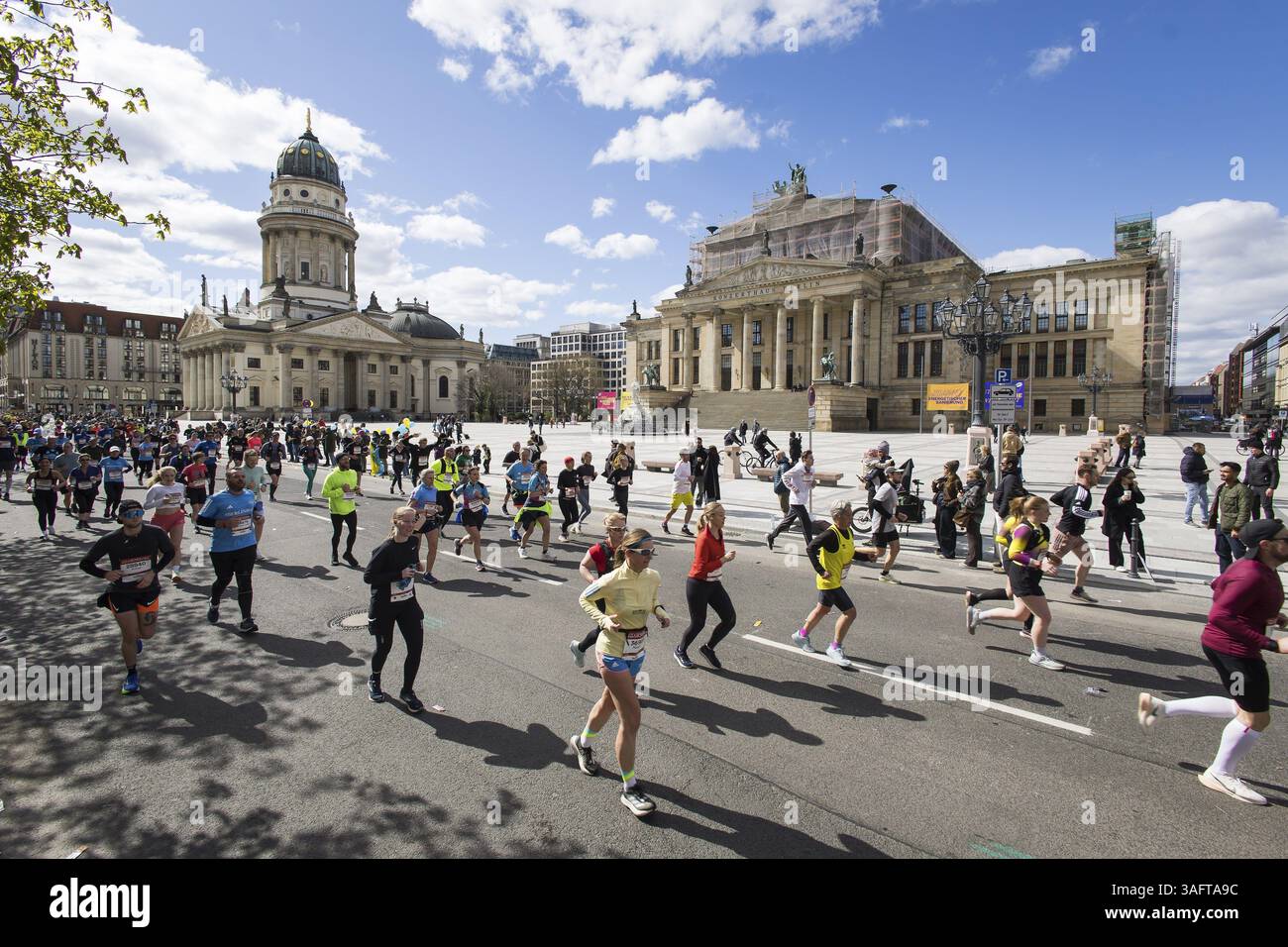 Runners in front of the German Cathedral and the concert hall am ...