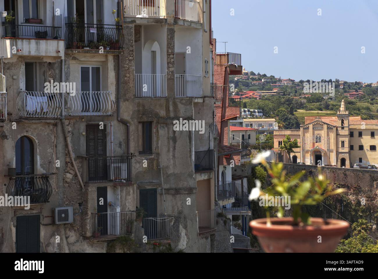 View of the multi-storey old buildings of Tropea with balconies and a ...