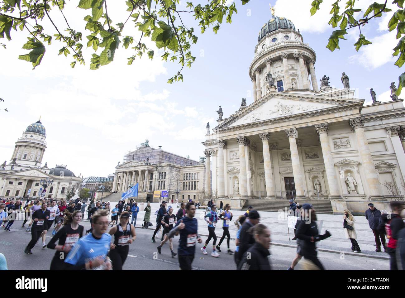 Runners in front of the German Cathedral, the concert hall and the ...