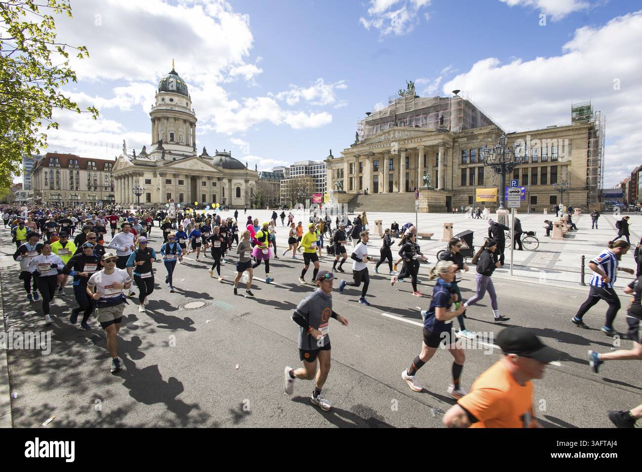 Runners in front of the German Cathedral and the concert hall am ...