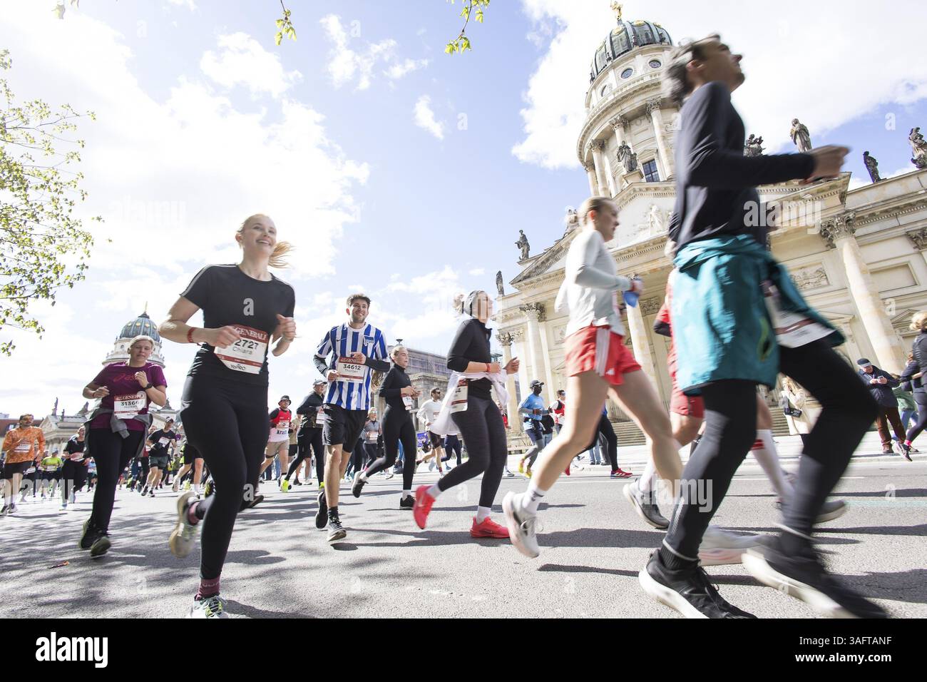 Runners in front of the German Cathedral, the concert hall and the ...