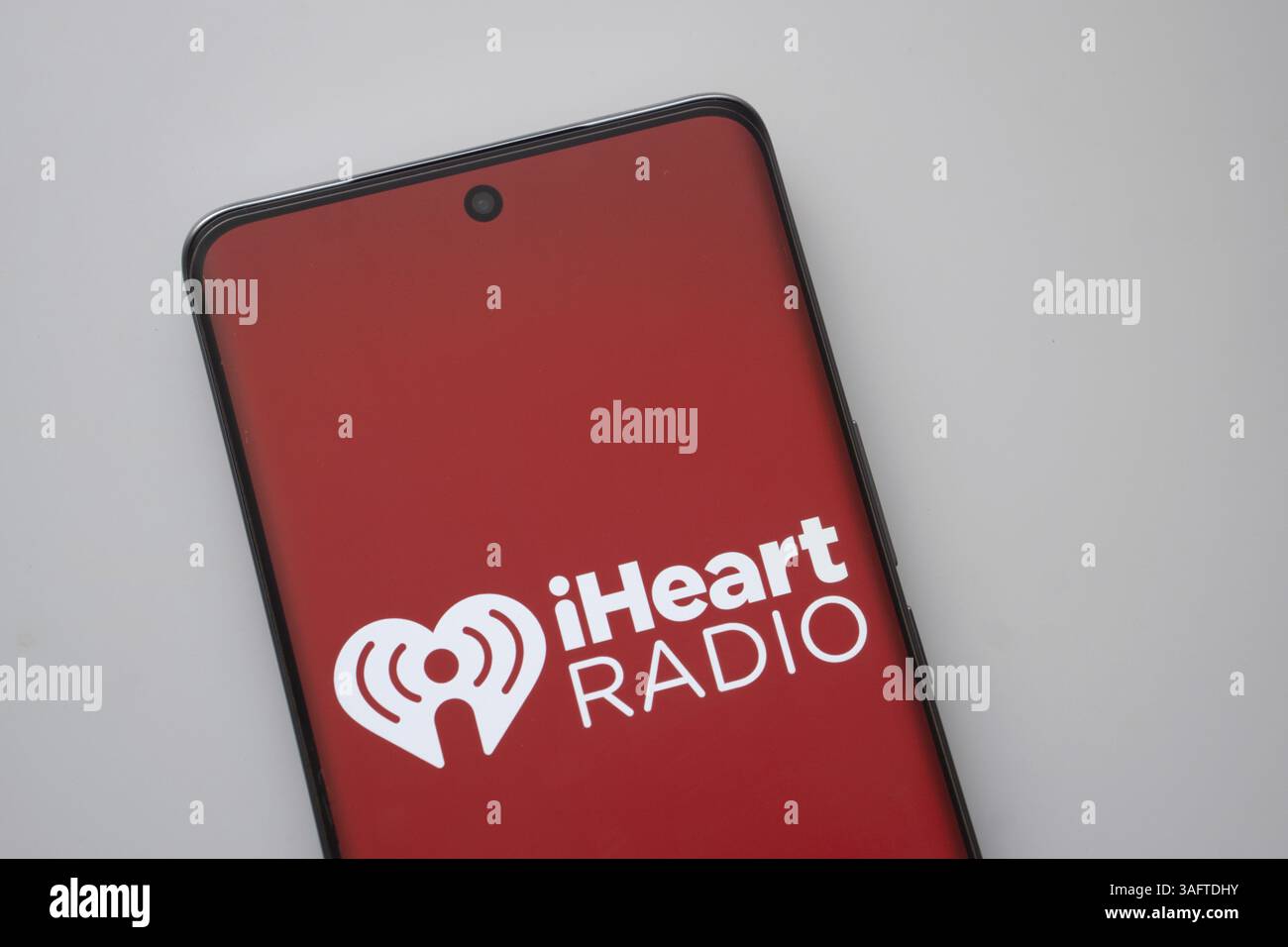The logo of the iHeartRadio is displayed on a smartphone screen Stock ...