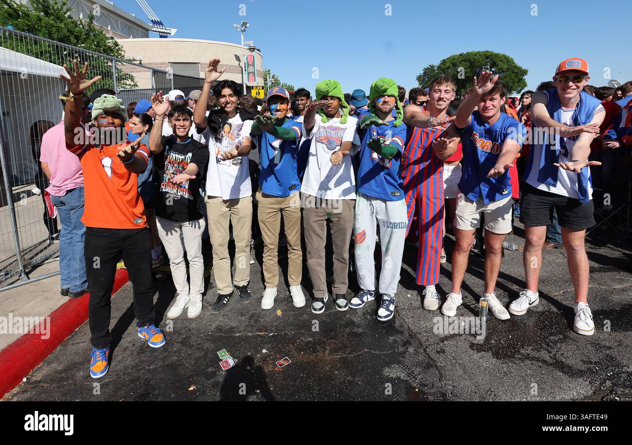 Florida Gator fans pose for a photo as the stand in line to enter the ...