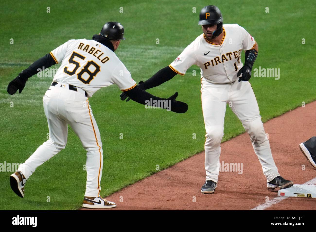 Pittsburgh Pirates' Joey Bart (14) celebrates with third base coach ...
