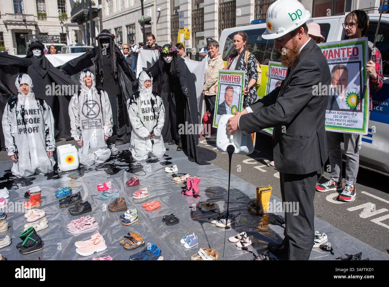 London, UK. 07th Apr, 2025. A protester seen pouring oil from the ...