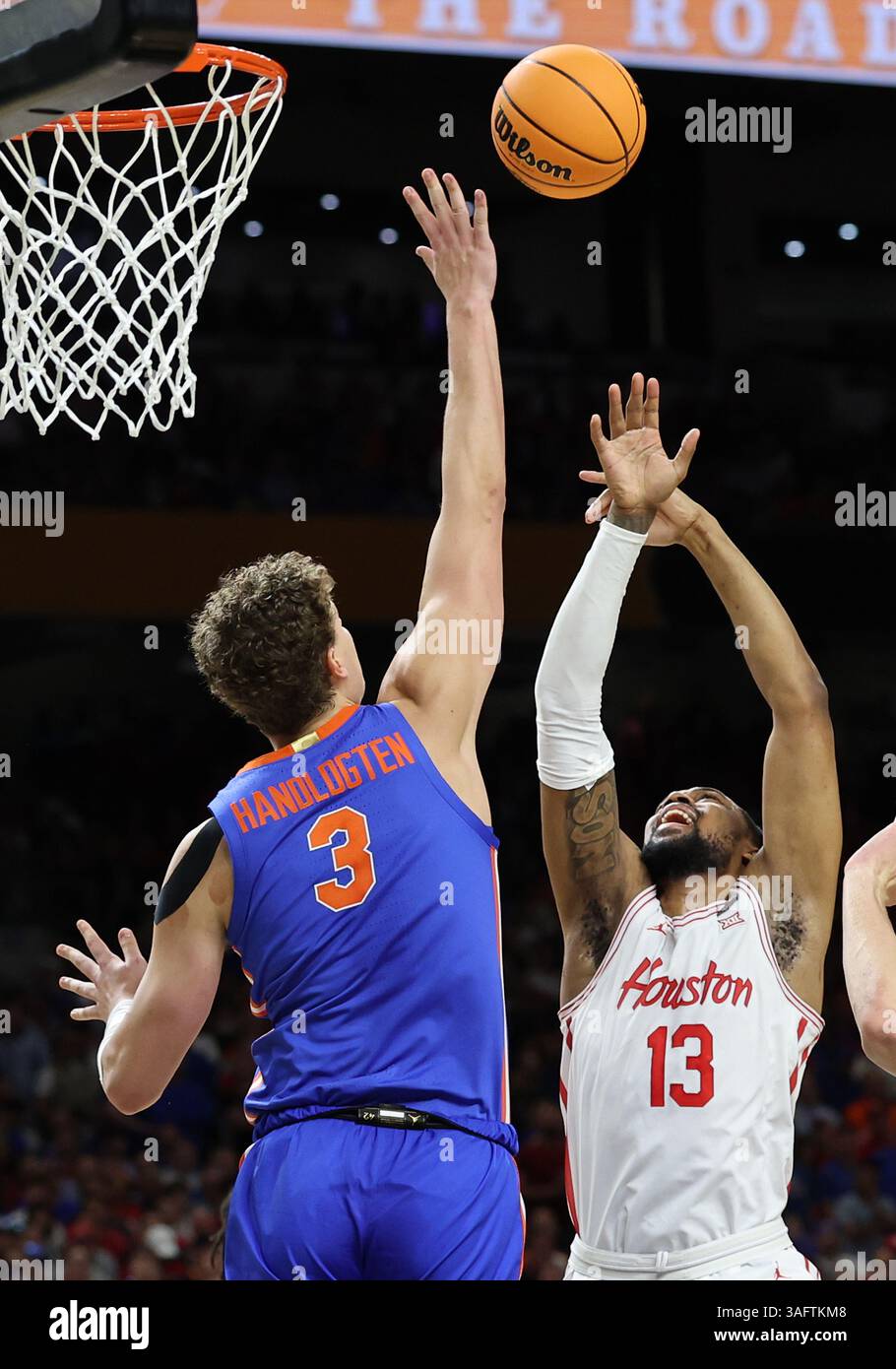 Houston forward J'Wan Roberts (13) shoots over Florida center Micah ...