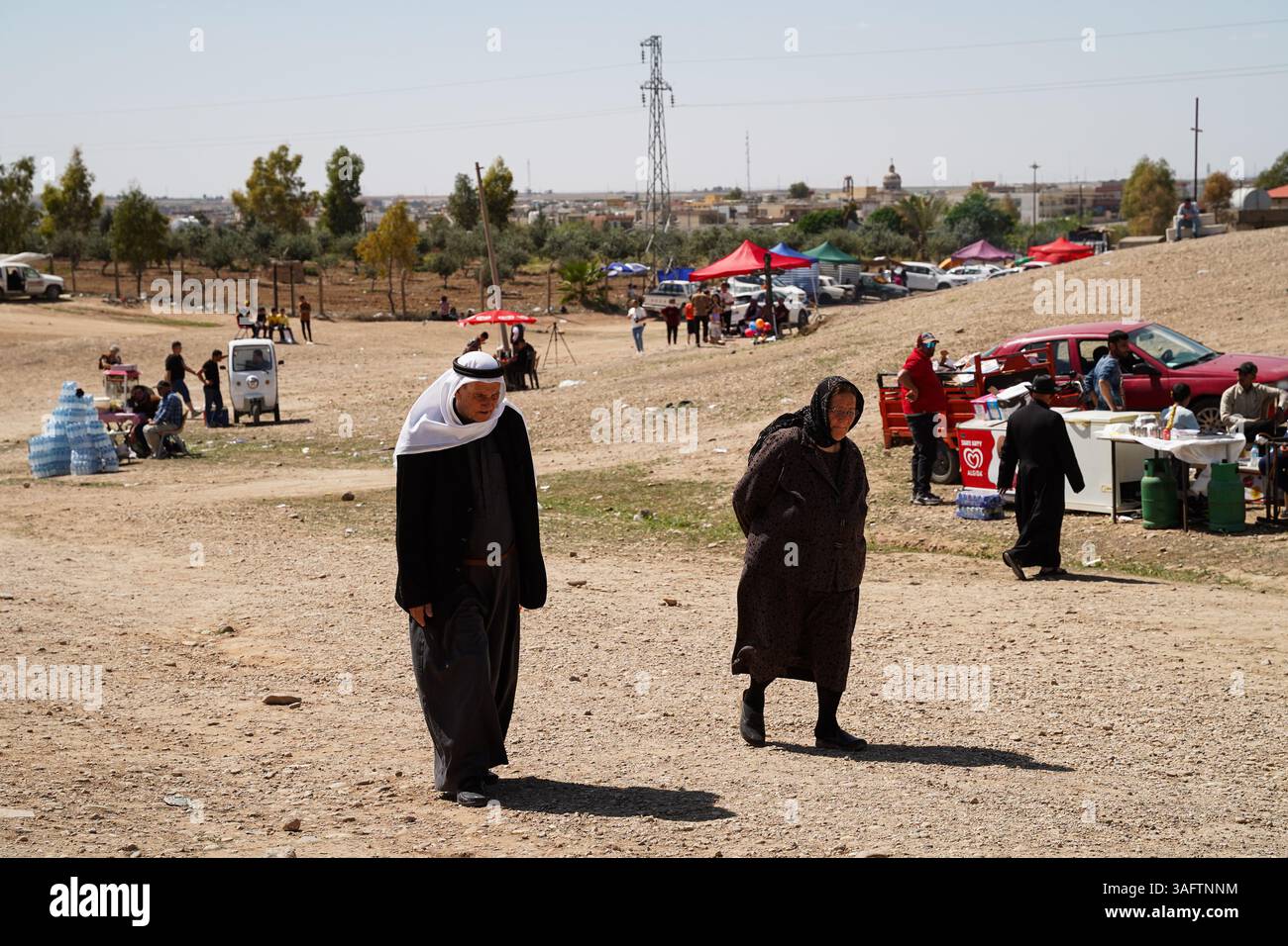 Qaraqosh, Iraq. 06th Apr, 2025. Iraqi Christians walk near the ruins of ...
