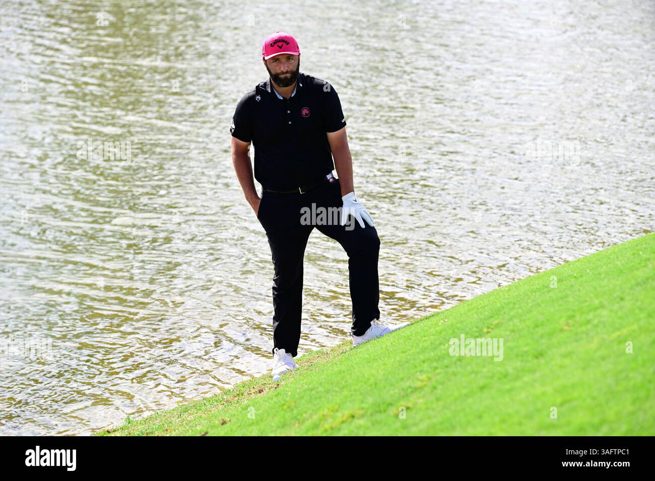 DORAL, FL - APRIL 06: Jon Rahm, waits his turn to chip on the 18th hole ...