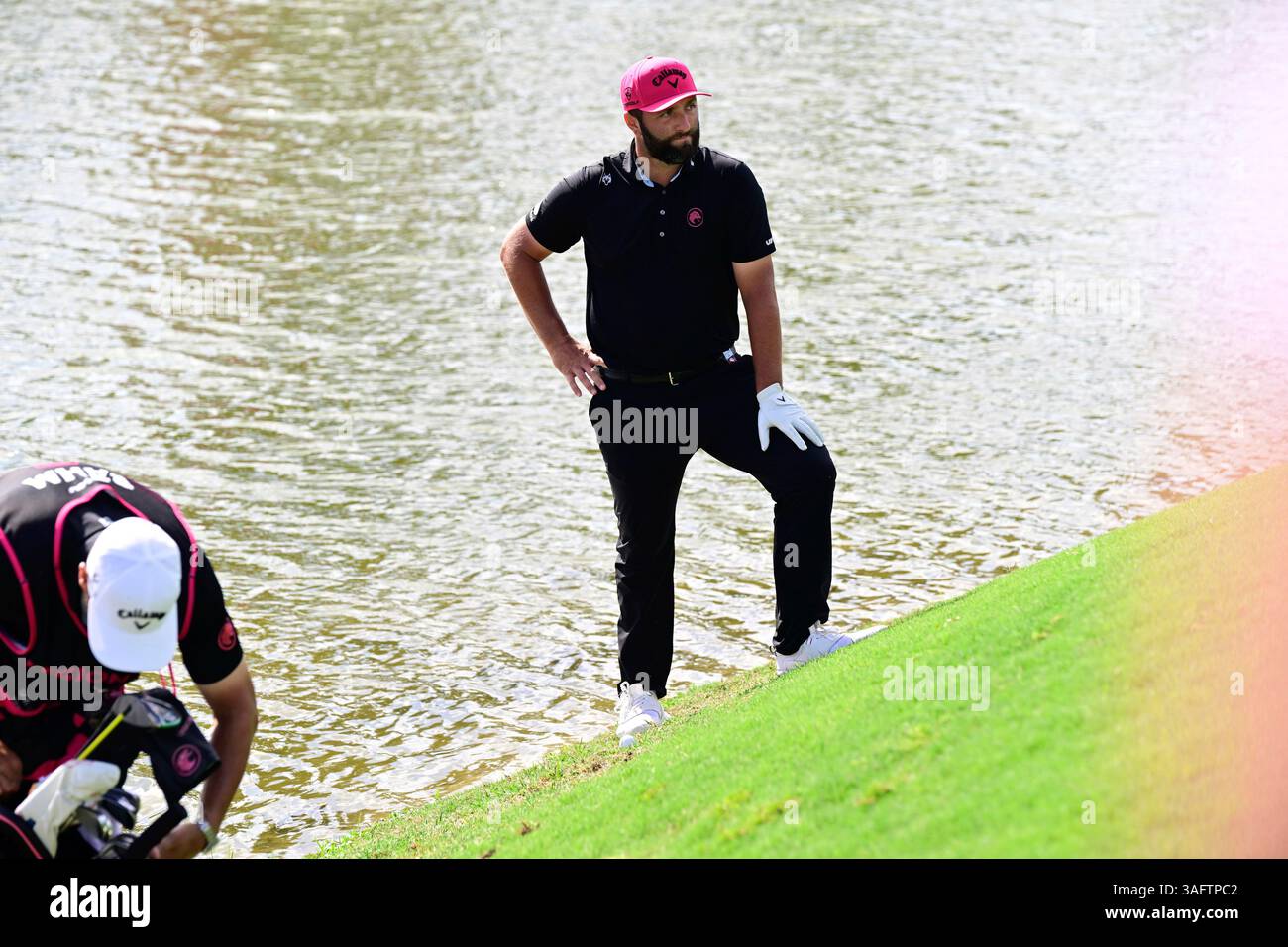 DORAL, FL - APRIL 06: Jon Rahm, waits his turn to chip on the 18th hole ...