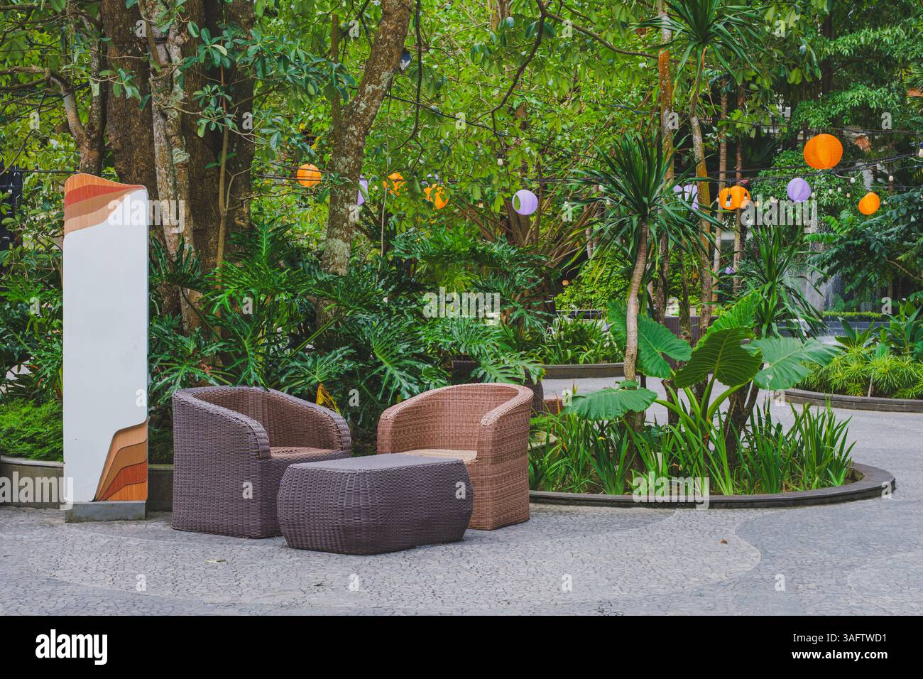 A comfortable outdoor lounge area with two rattan chairs and a table ...