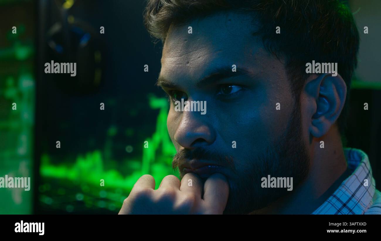 Concentrated focused Arabian Indian man analysing chart crypto currency ...