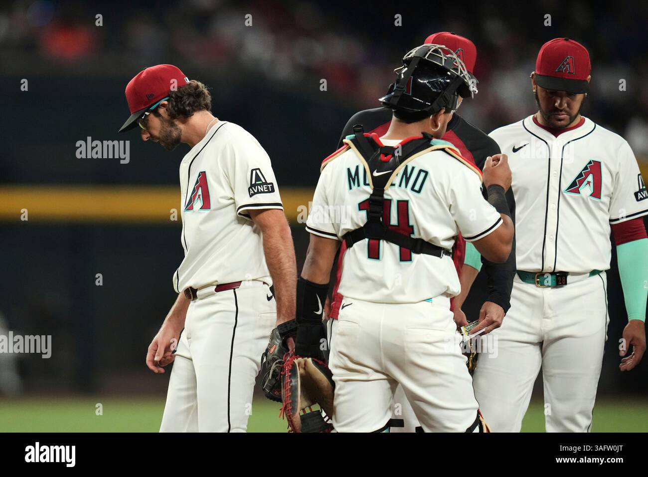 Arizona Diamondbacks starting pitcher Zac Gallen, left, leaves the game ...