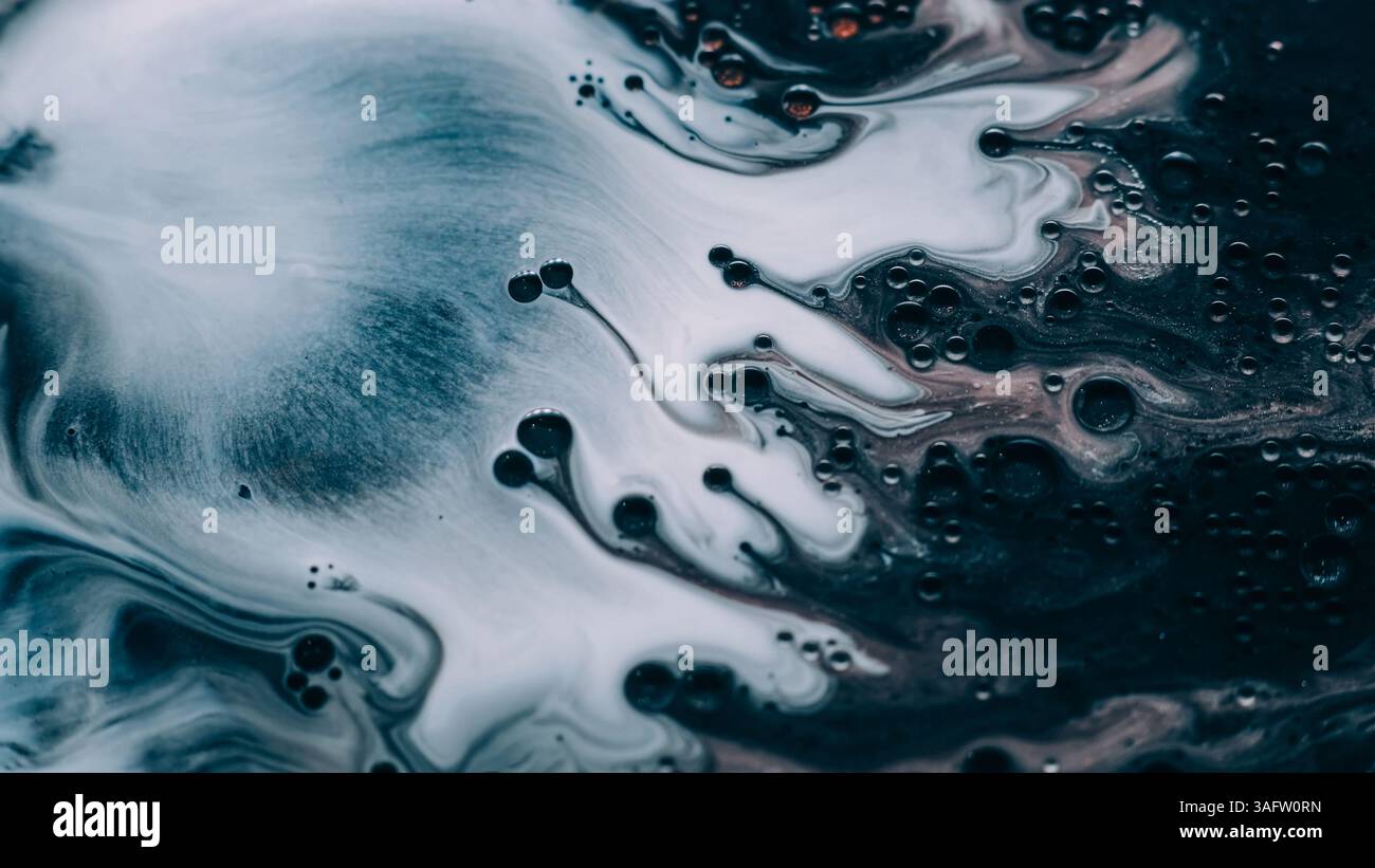 Bubble fluid. Oil liquid texture. Defocused dark black white paint in ...