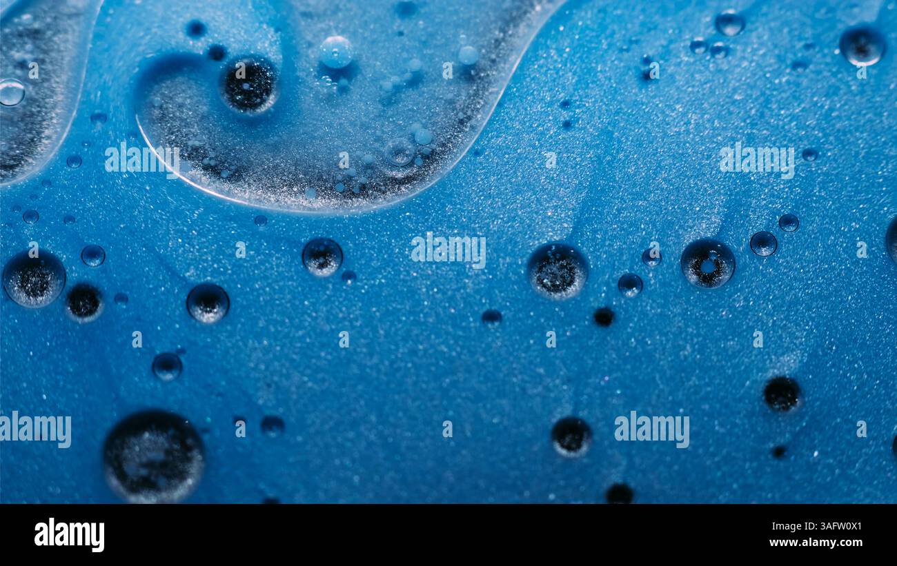 Bubble fluid. Oil liquid texture. Defocused blue color paint in water ...