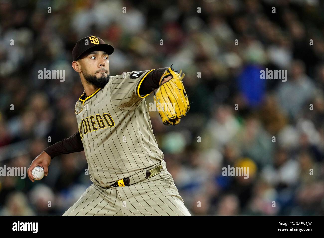 San Diego Padres pitcher Robert Suarez throws to an Athletics batter ...