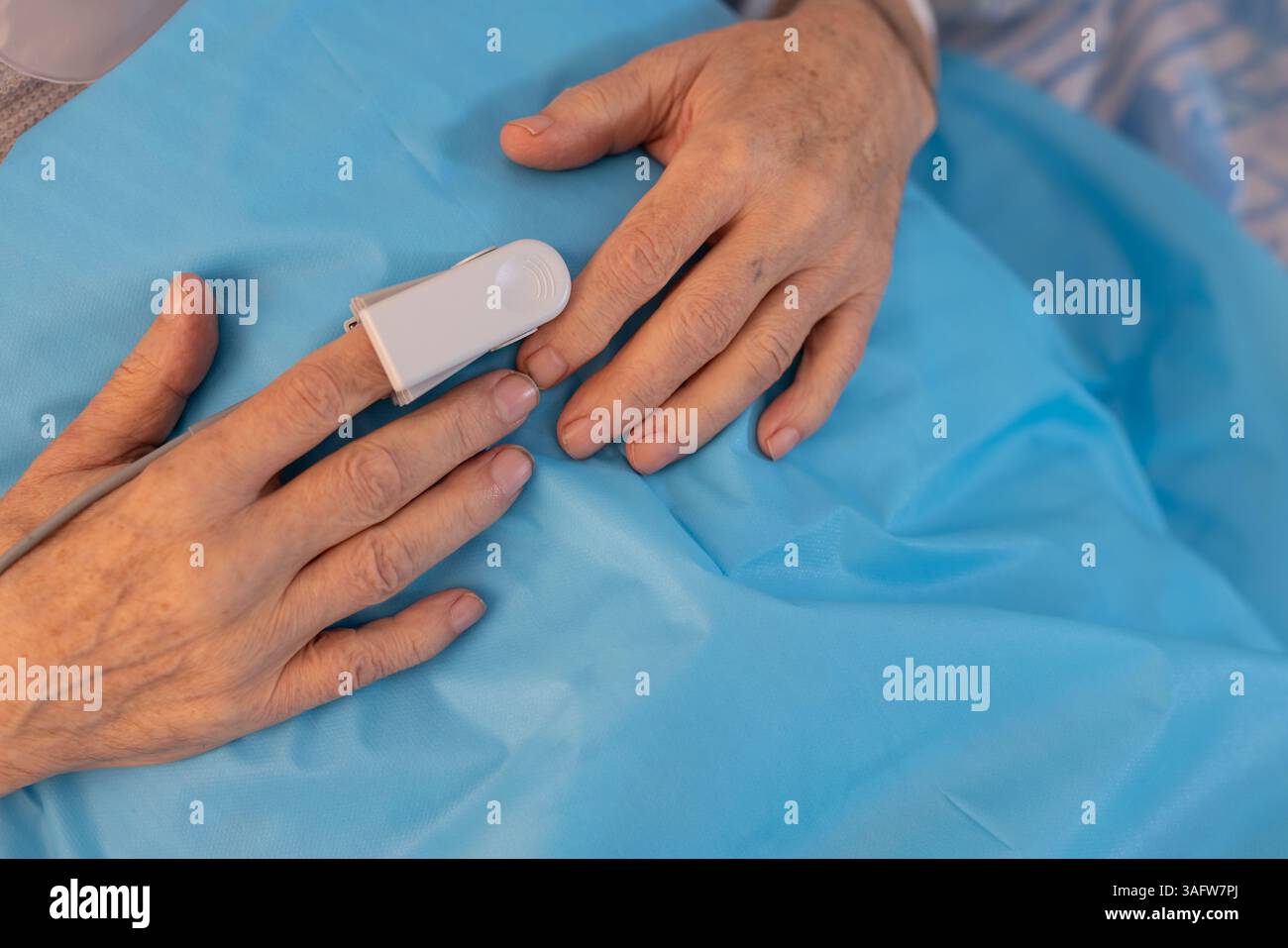 Close-up of elderly patient hand with pulse oximeter on finger ...